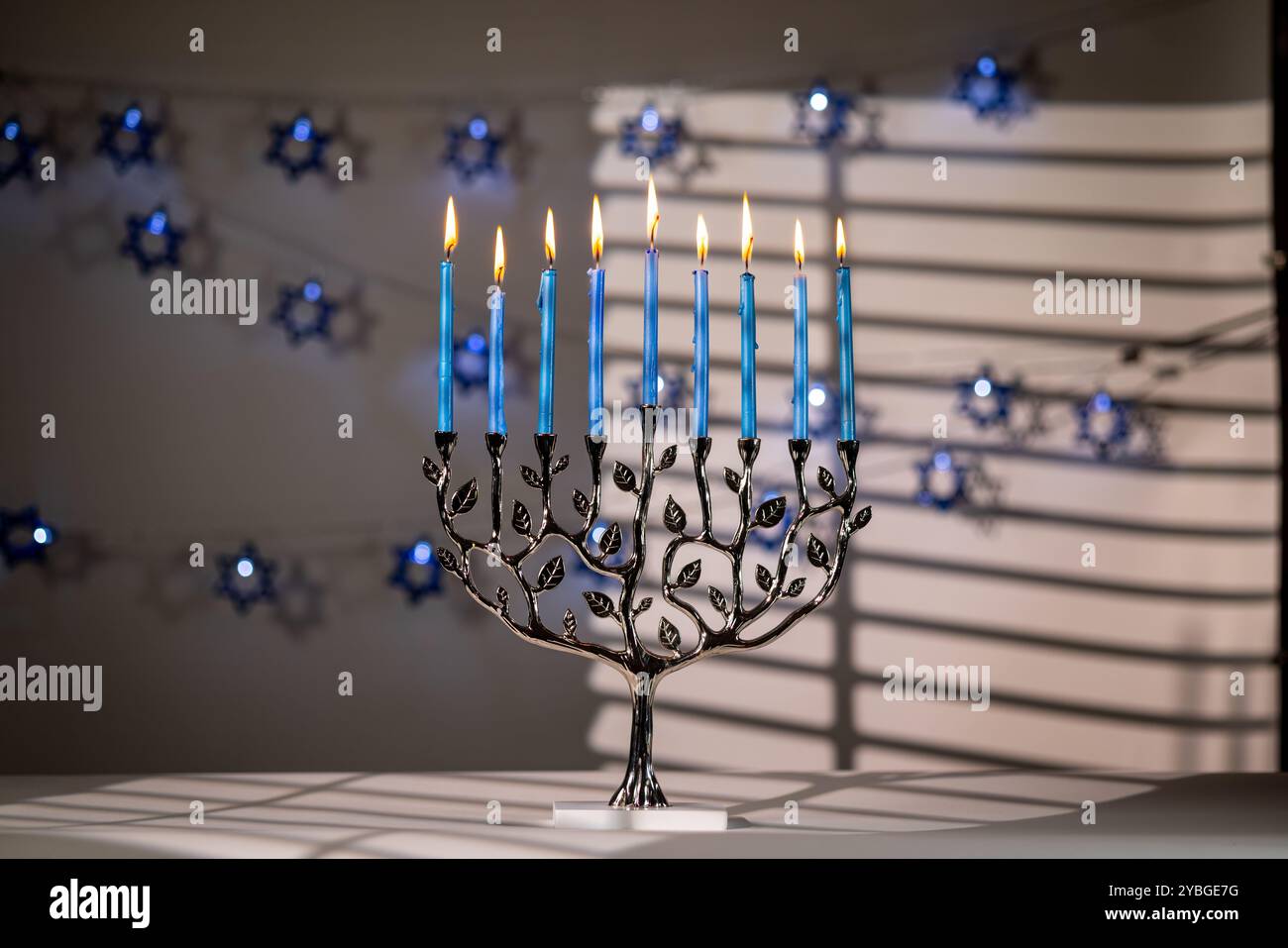 Silver Menorah with Blue Candles and Star of David Backdrop by Window ...