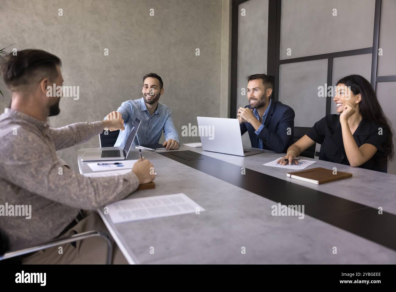 Two successful male business colleagues making fist bumps friendship ...