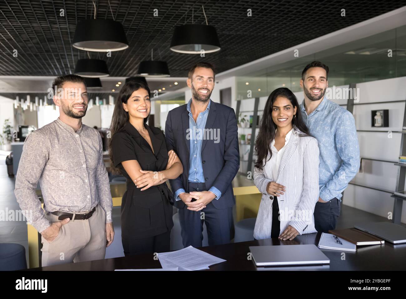 Happy positive multiethnic business group posing for professional ...