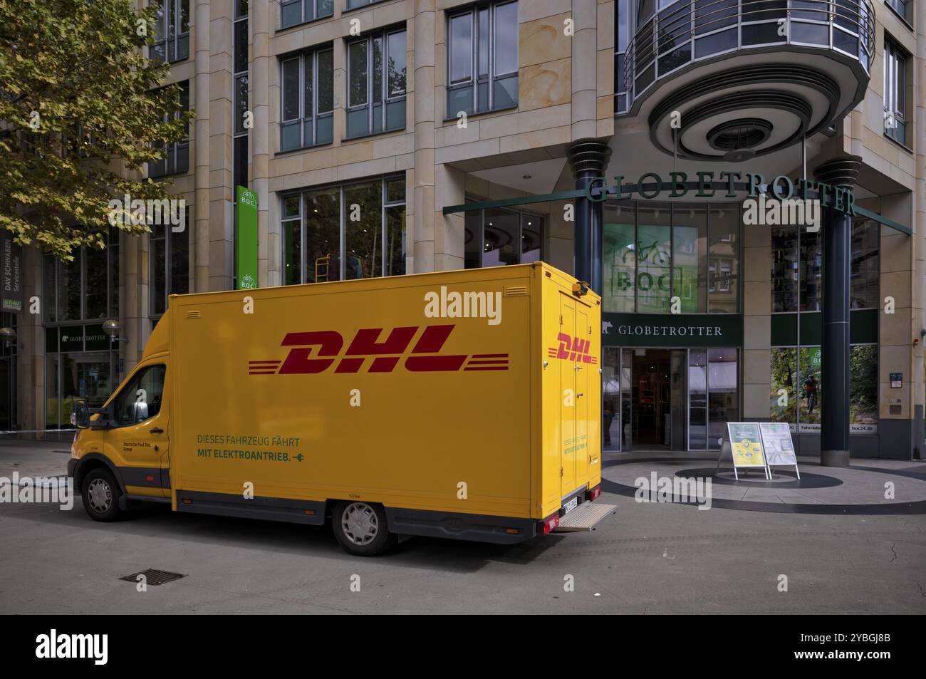 DHL delivery vehicle, logo, delivery, parked in front of Globetrotter ...