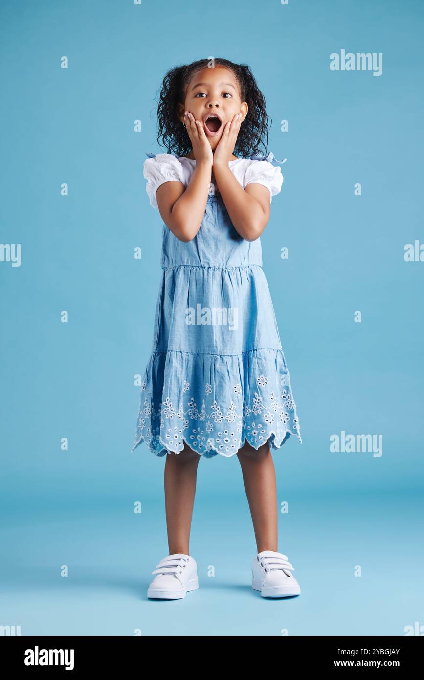 Hands, surprise and portrait of child in studio for announcement ...