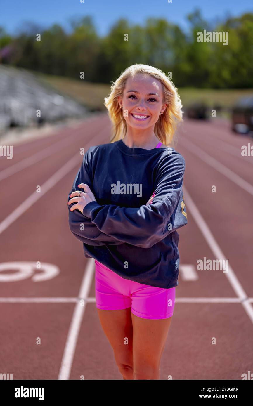 Radiant blonde athlete shines at the track on a stunning day, embodying ...