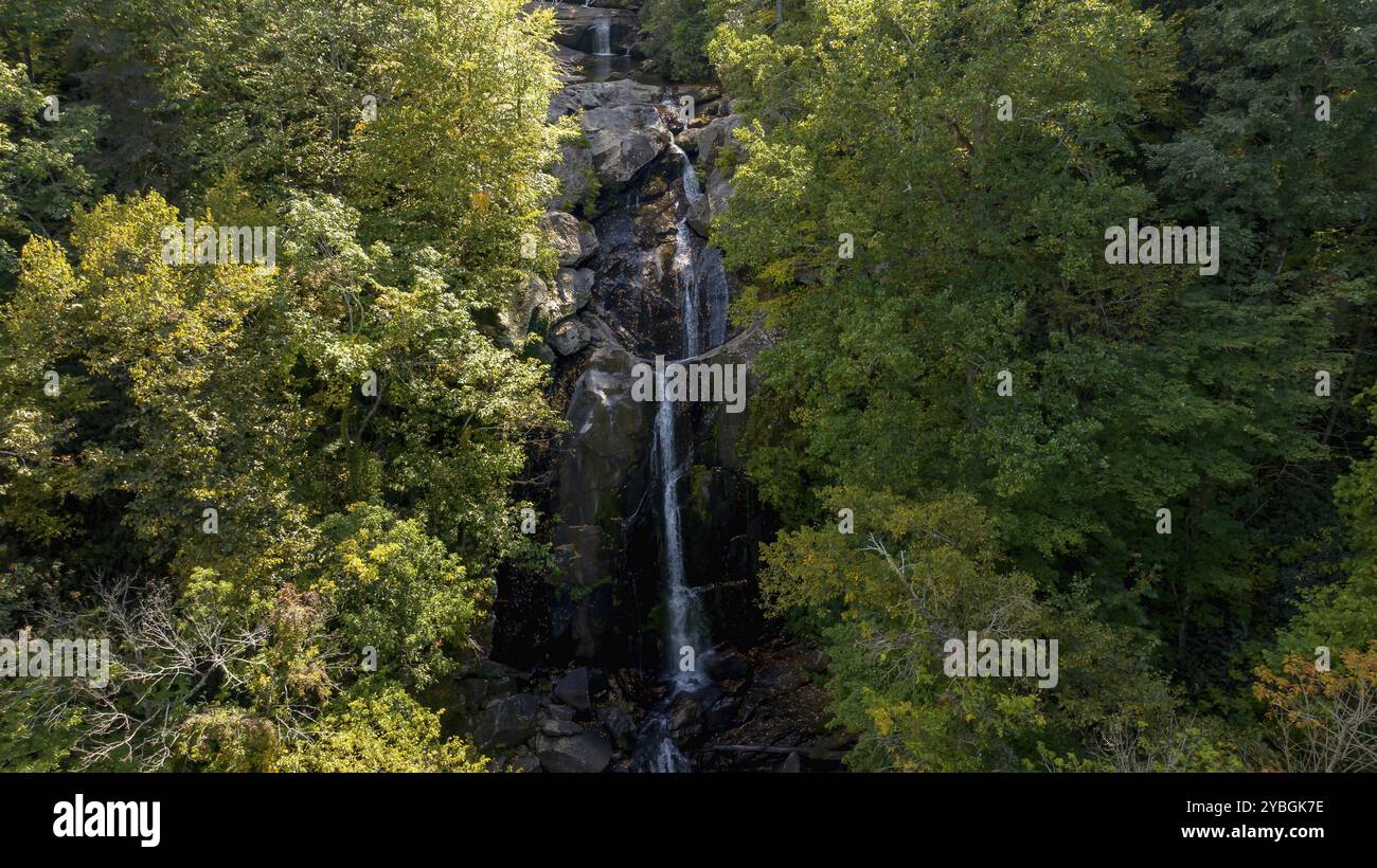A beautiful waterfalls set in a mountain environment as the leaves start changing for fall Stock ...