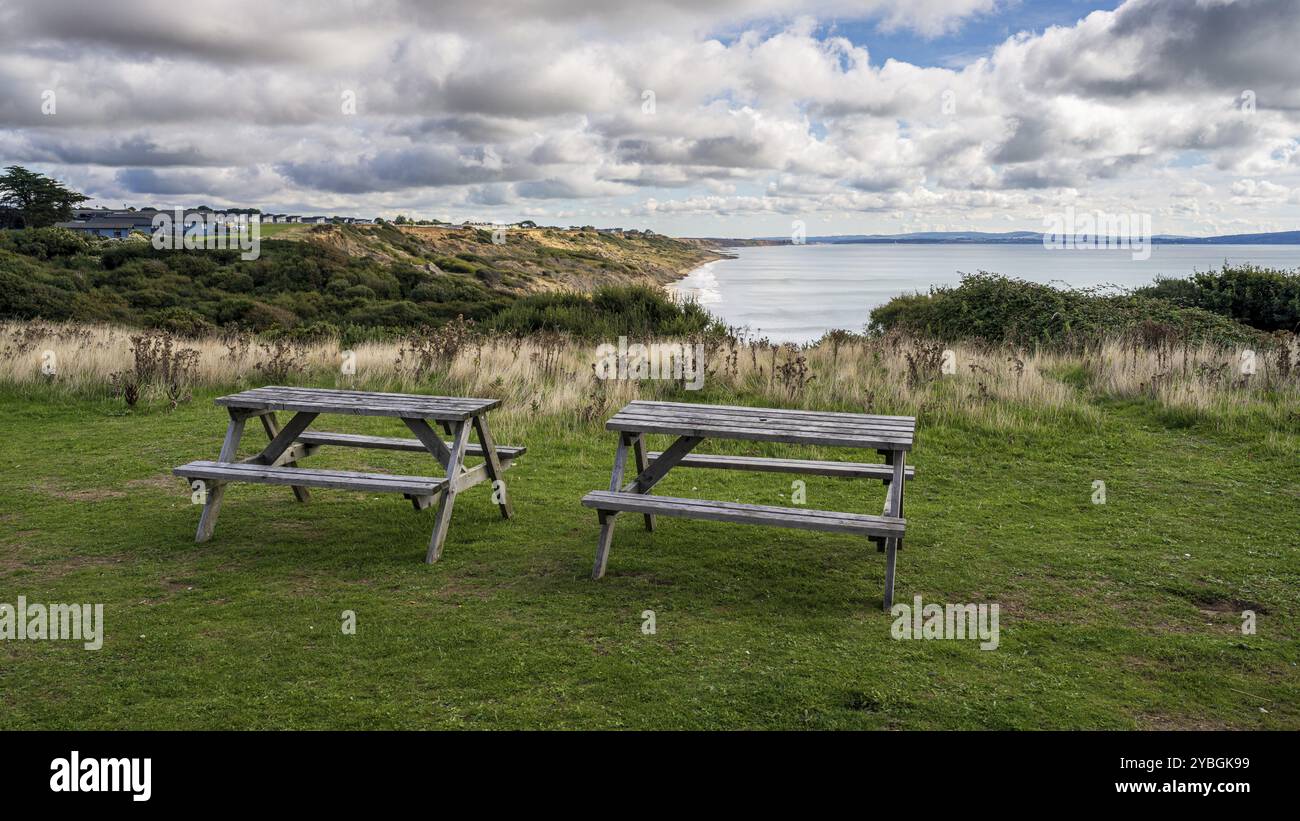 Picnic benches with views of the cliffs and Naish Beach in Highcliffe ...