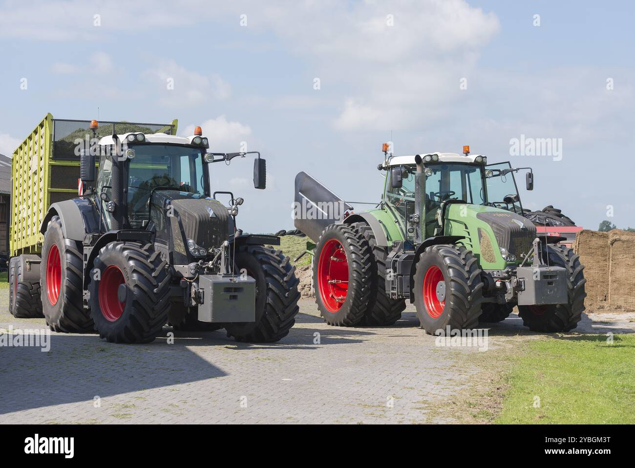 Pause during silage of shredded grass with two tractors and a loader ...