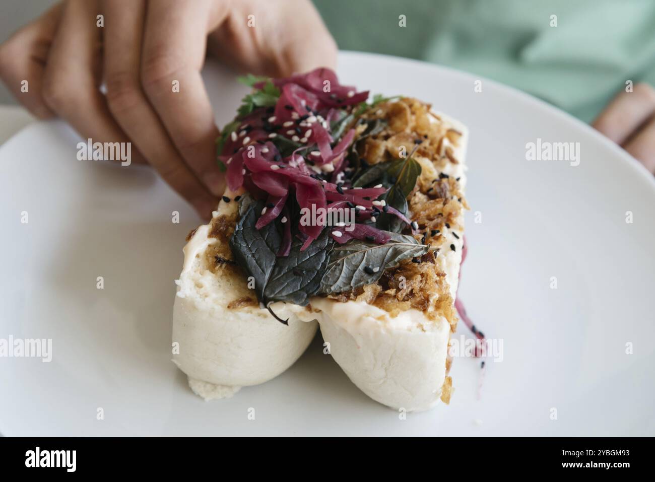Close up photo of a traditional bao steamed bun with pork filling at a ...