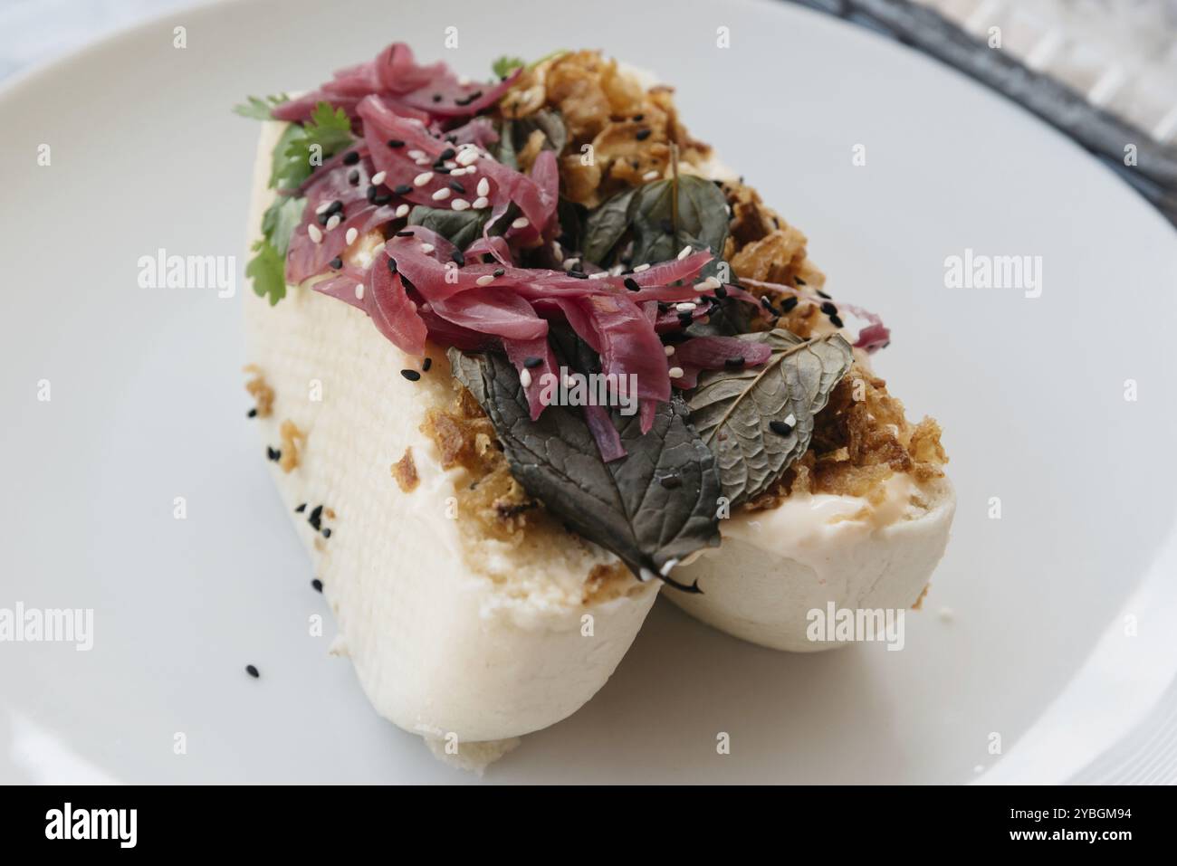 Close up photo of a traditional bao steamed bun with pork filling at a ...