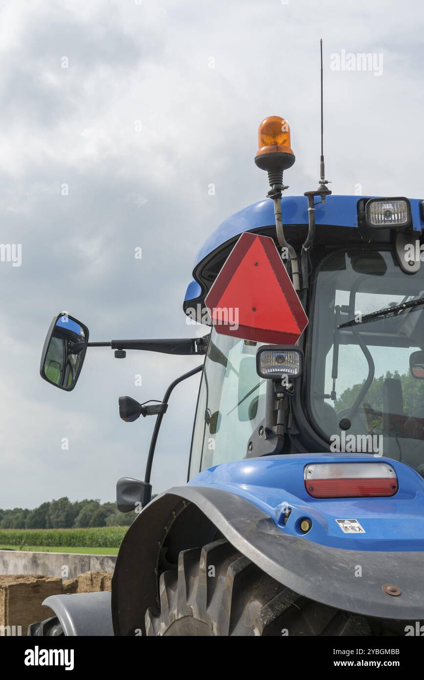 Blue tractor with detail of the truncated warning triangle for motor ...