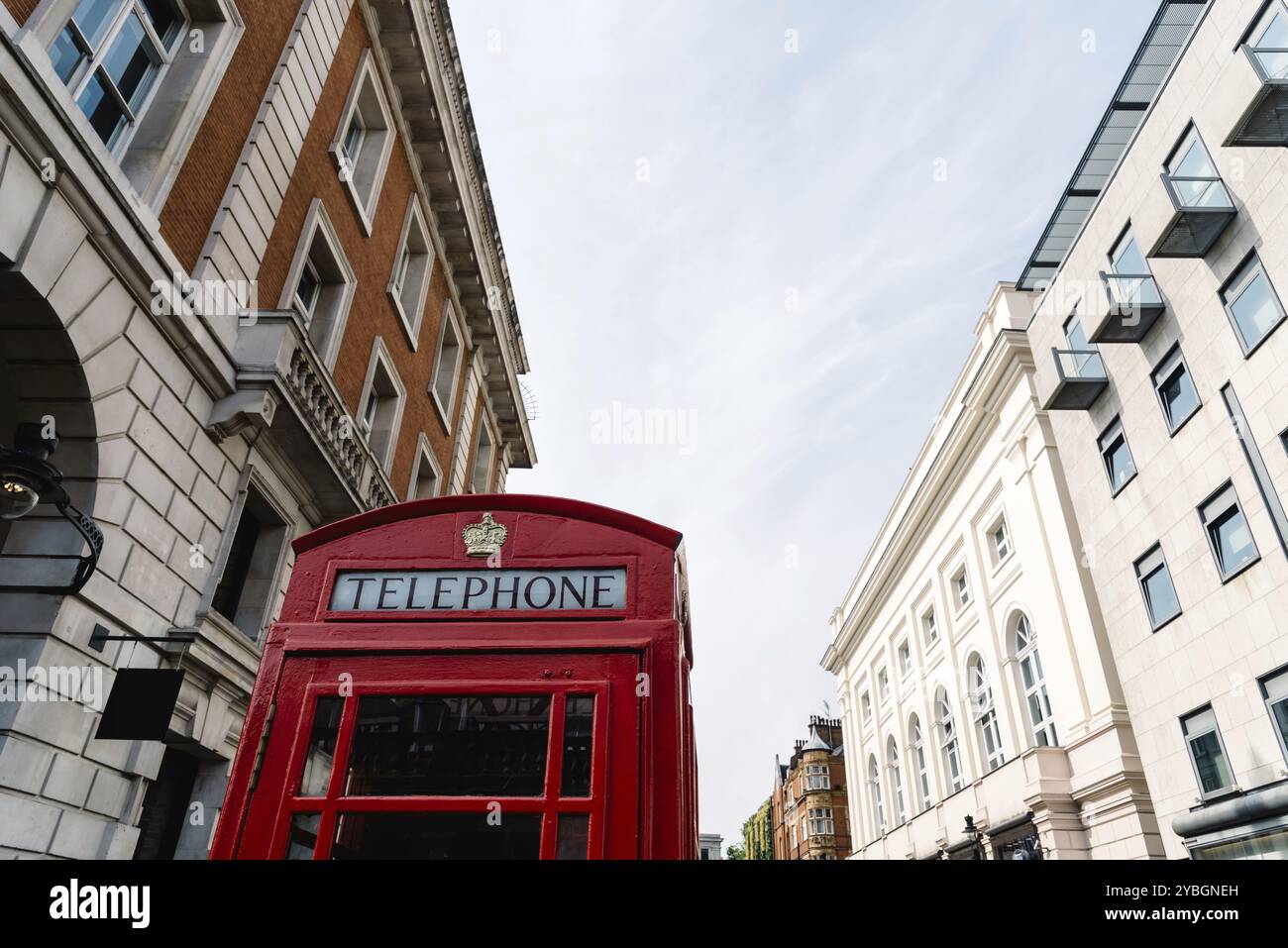 Traditional red telephone box in London, England, UK. Low angle view ...