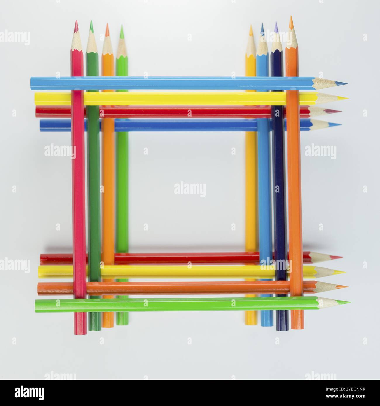 Collection of stacked colored pencils in a square in top view as ...