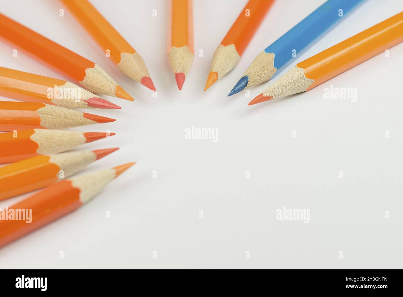 Collection of colored pencils in a half circle shape as background ...