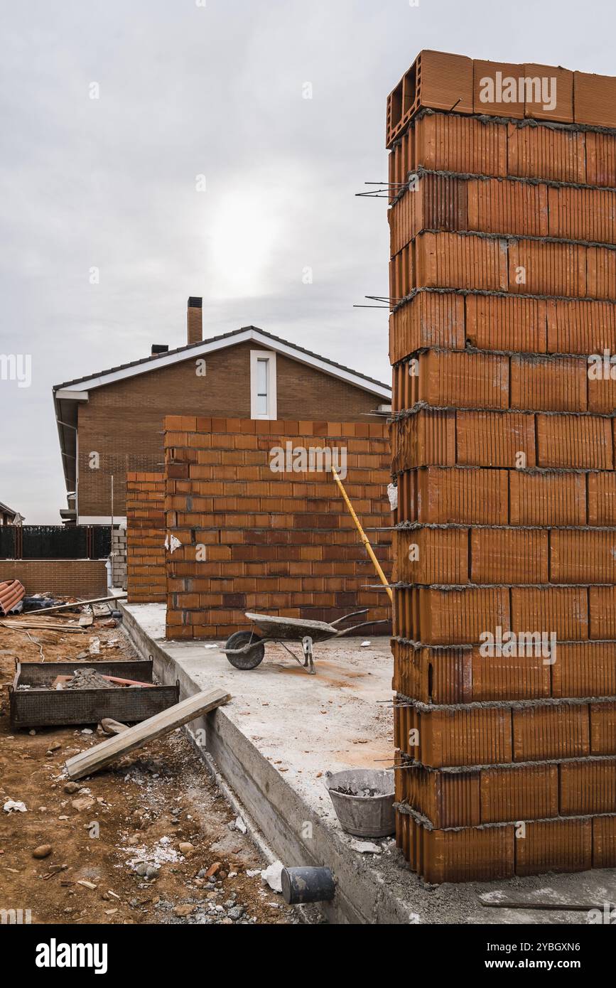 Works of construction of thermal clay block walls in construction site ...