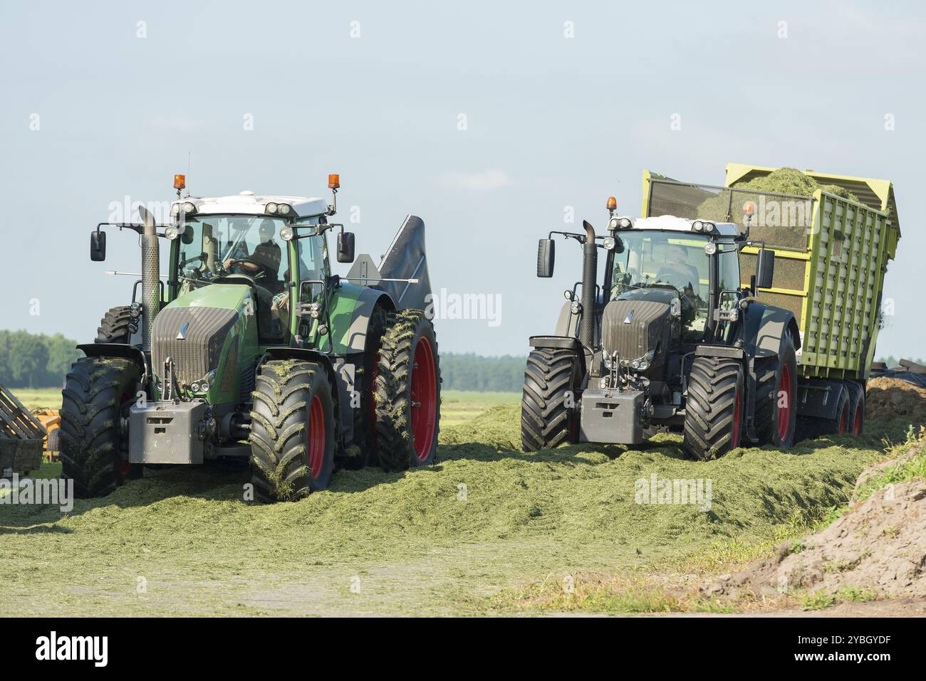 Two tractors harvest in field hi-res stock photography and images - Alamy