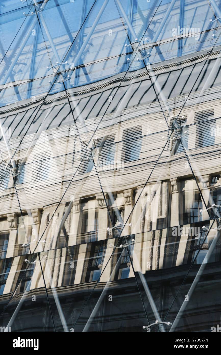 Reflections of old building in modern architecture glass facade Stock ...