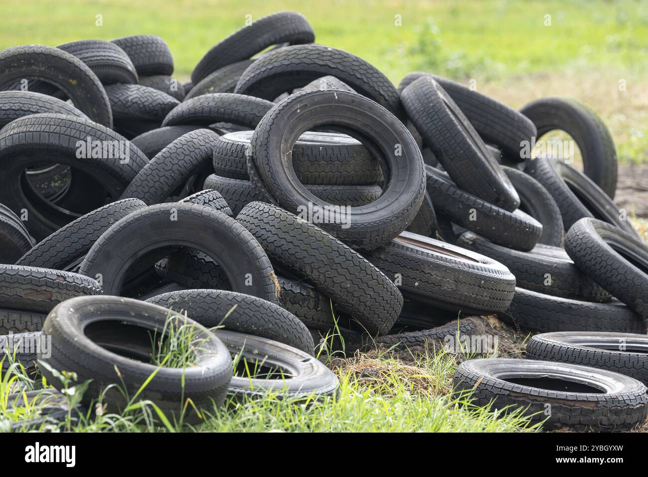 Old worn tires in a grass field on a Dutch farm Stock Photo - Alamy