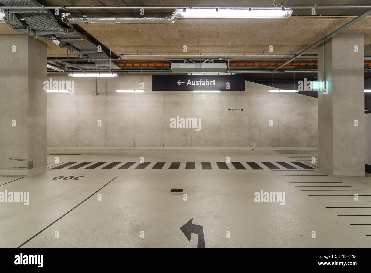 Underground car park with exit sign in German Stock Photo - Alamy
