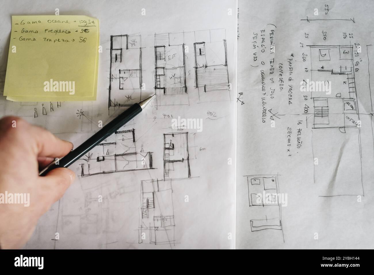 Man architect drawing plan or design by pencil on paper at office desk ...