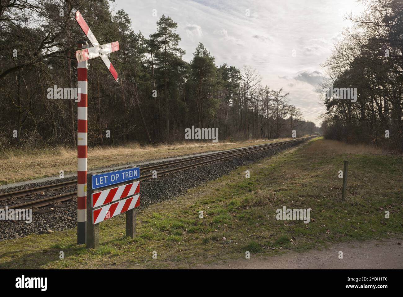 Unguarded, light rail railway crossing without barriers and warning ...