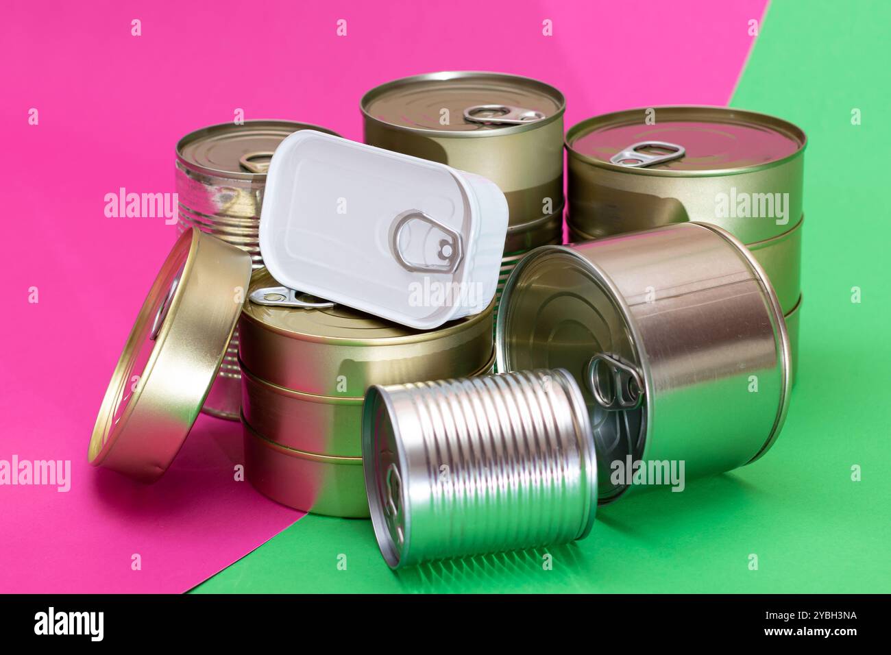A Group of Stacked Tin Cans on Split Green and Cyan Background. Canned ...