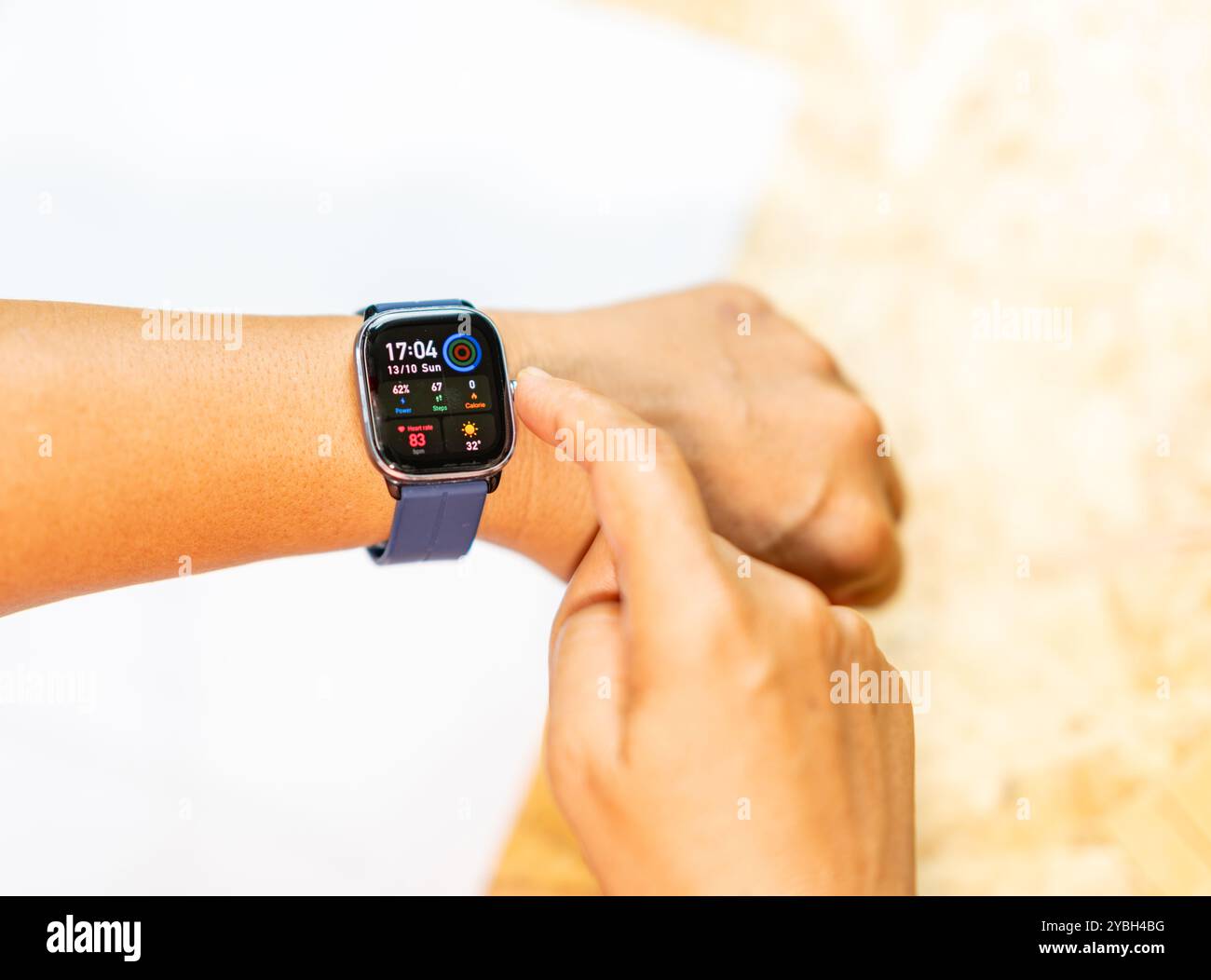 Close up woman checking smart watch before exercising on blur ...