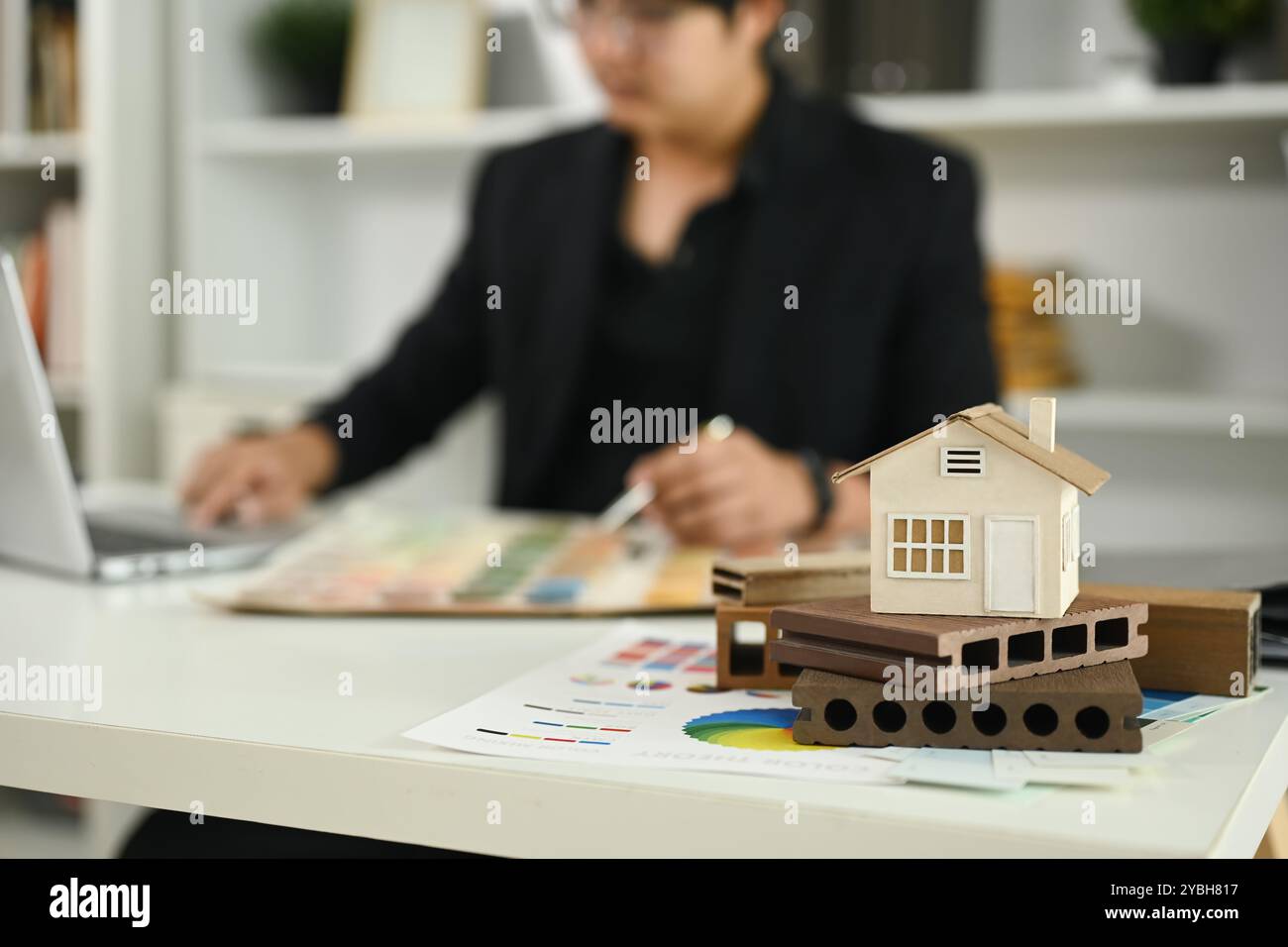 A small house model on top a stack of material sample at interior ...