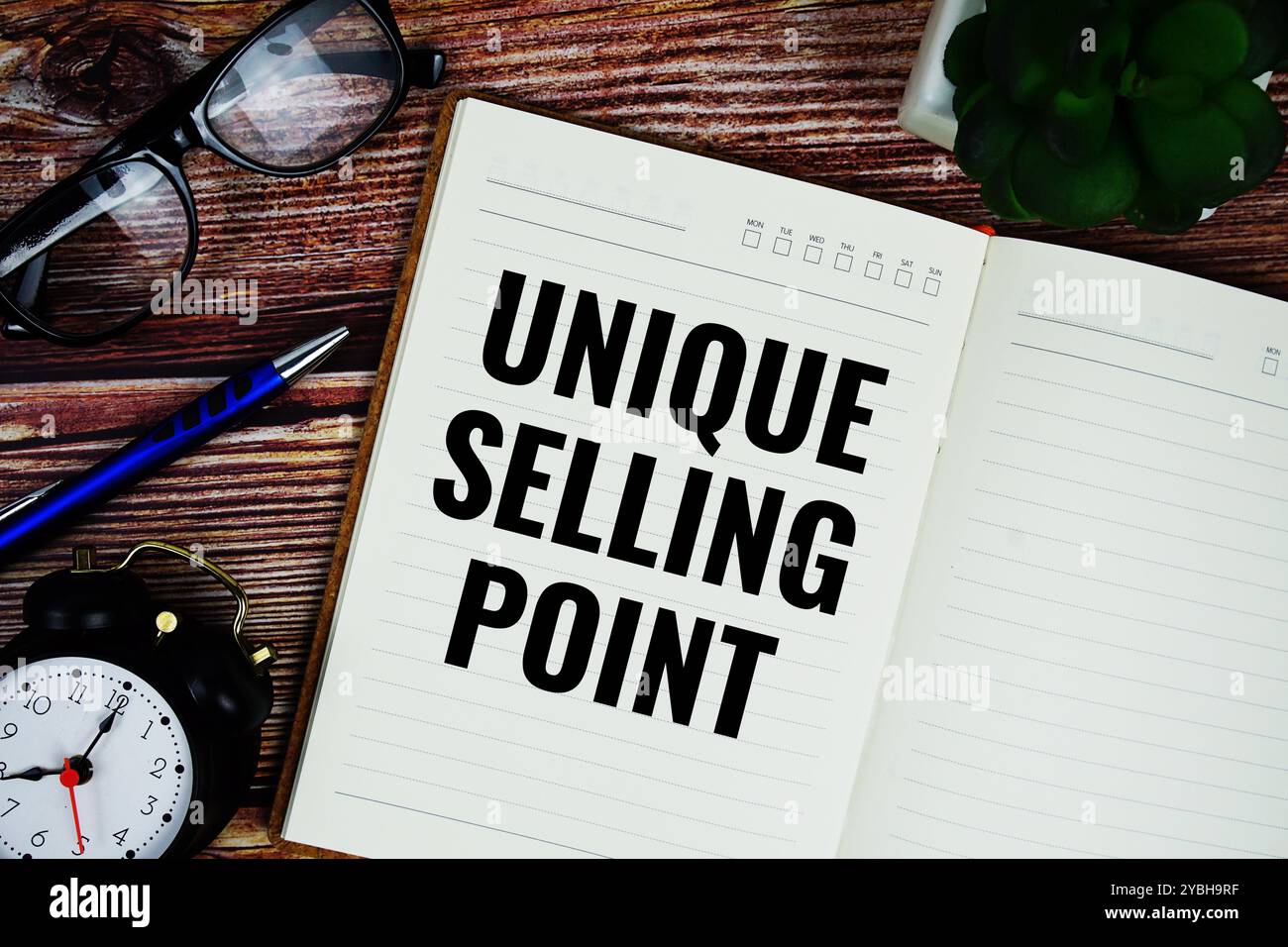 Unique Selling Point USP text on notebook page with alarm clock top ...