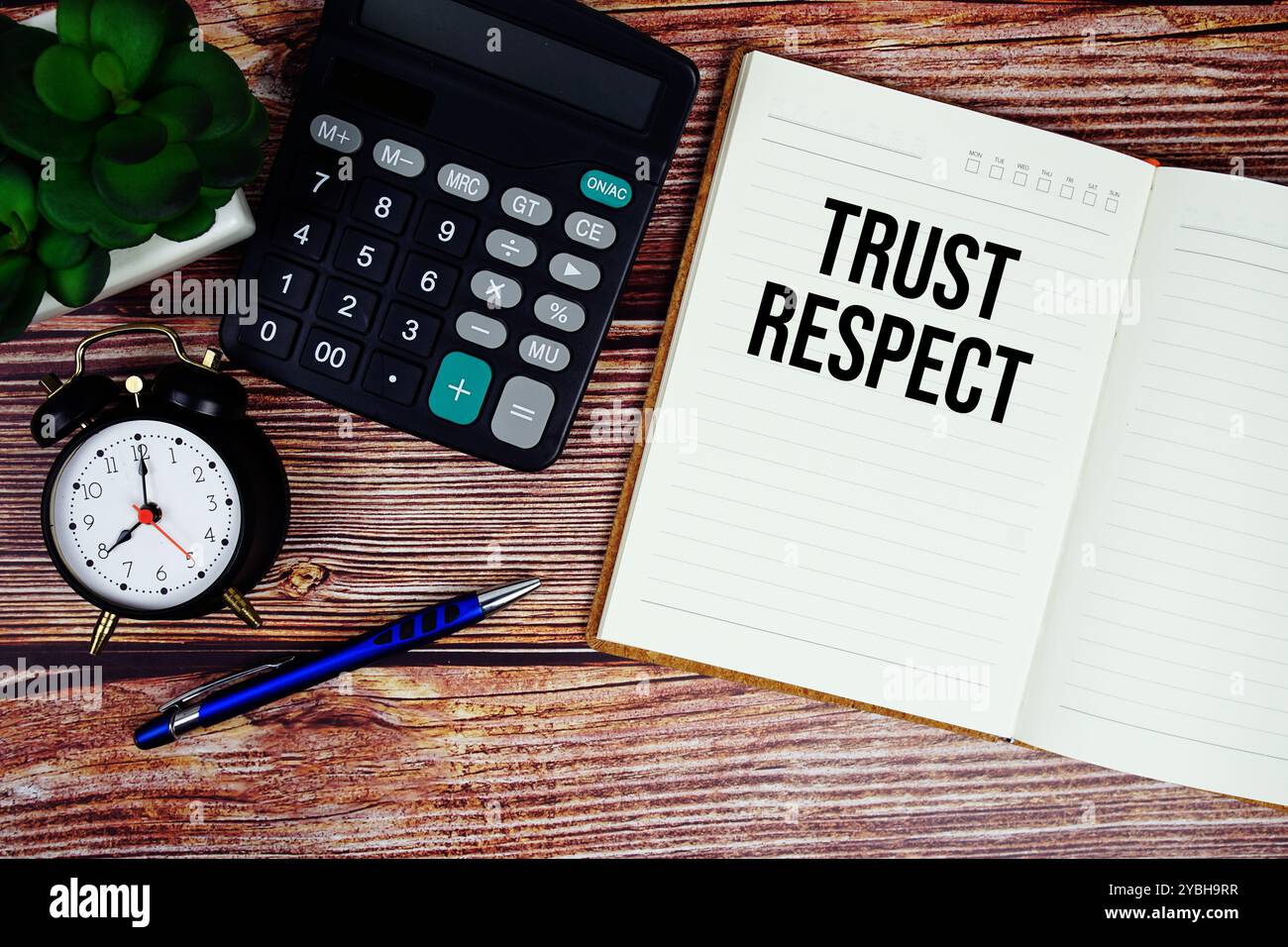 Trust Respect text written on paper torn with calculaton and alarm ...