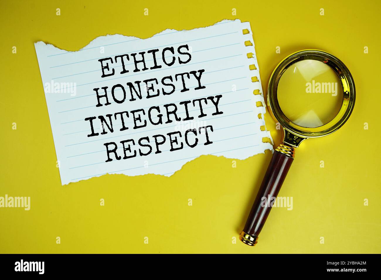 Ethics, Honesty, Integrity, Respect text on paper torn with magnifying ...