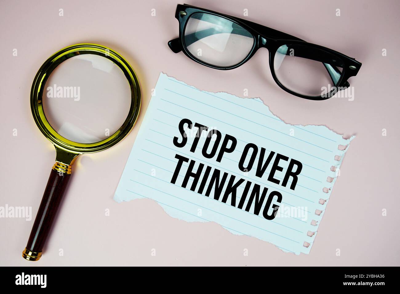 Stop Over Thinking text written on paper torn with magnifying glass top ...