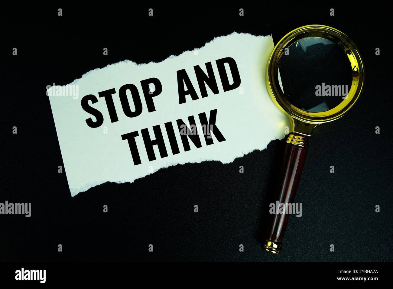 Stop and Think quotes text on paper torn with magnifying glass top view ...