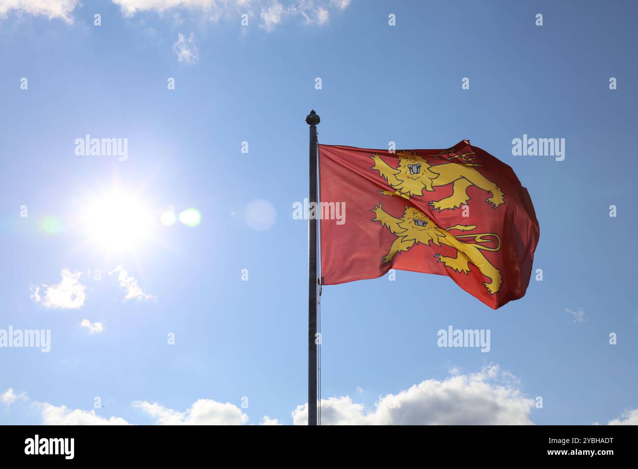 Flag of Normandy, two yellow lions on a red background, fluttering on a sunny sky Stock Photo ...