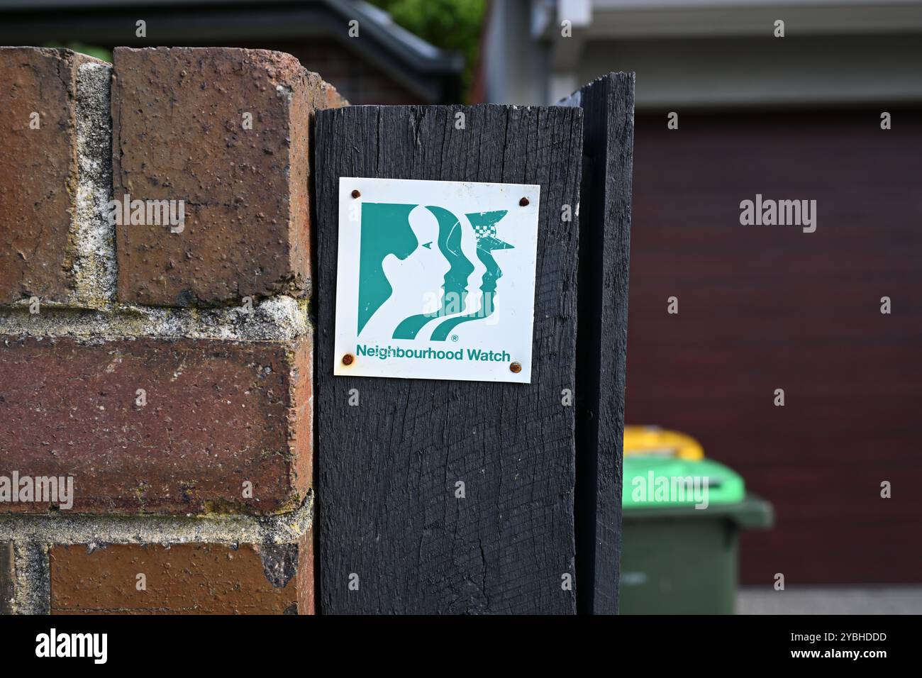 Square Neighbourhood Watch plaque or sign nailed to a painted grey ...