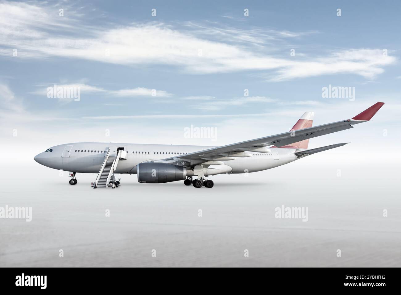 Wide body passenger airplane with boarding stairs on bright background ...