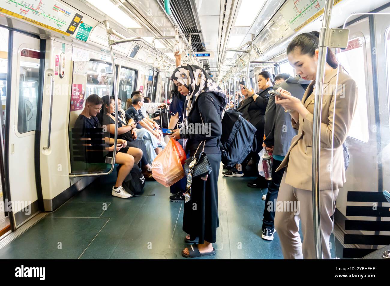 Commuters in a metro train in Singapore Stock Photo - Alamy