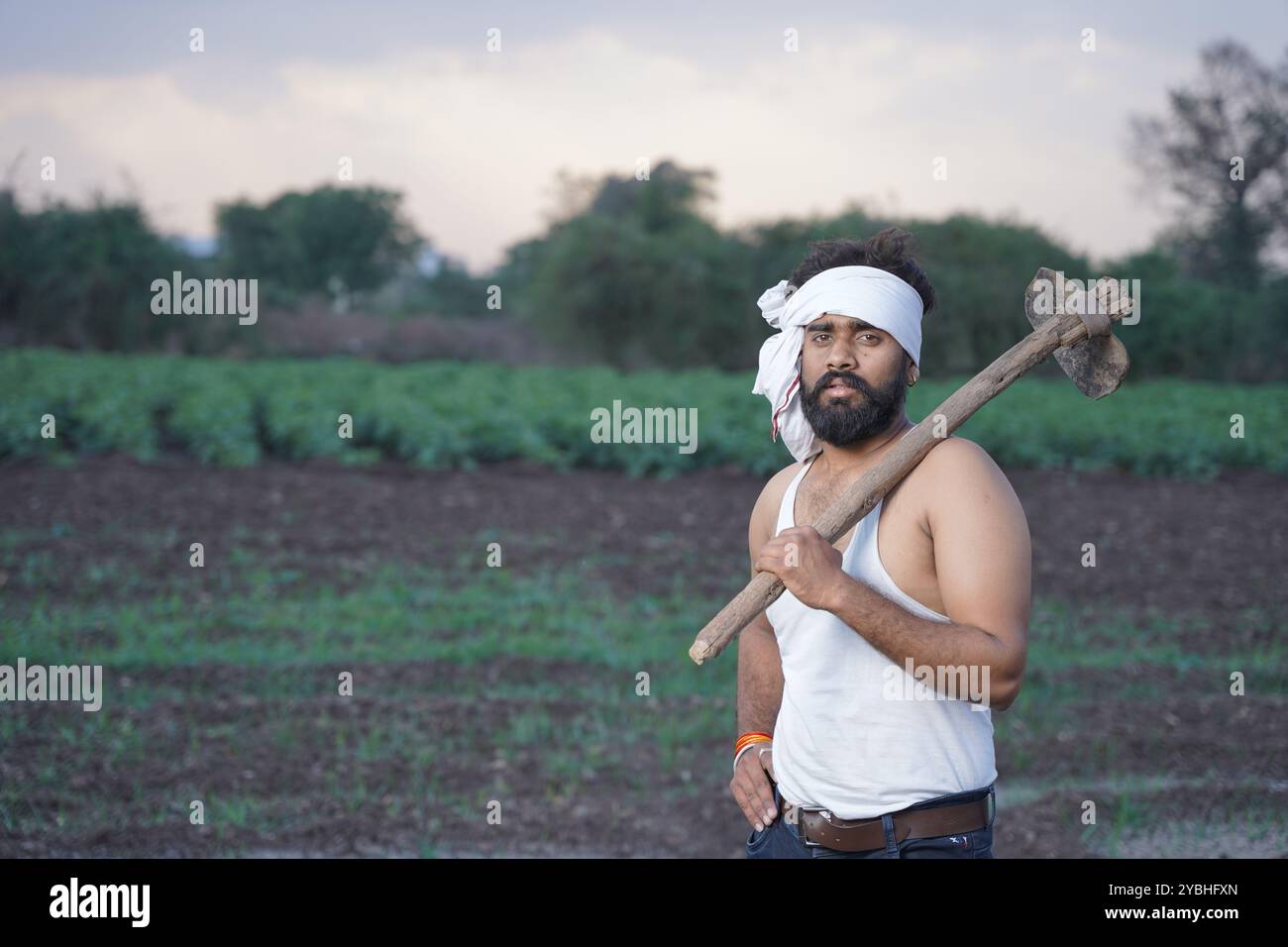 Indian farmer, young, laboring on the field Stock Photo - Alamy