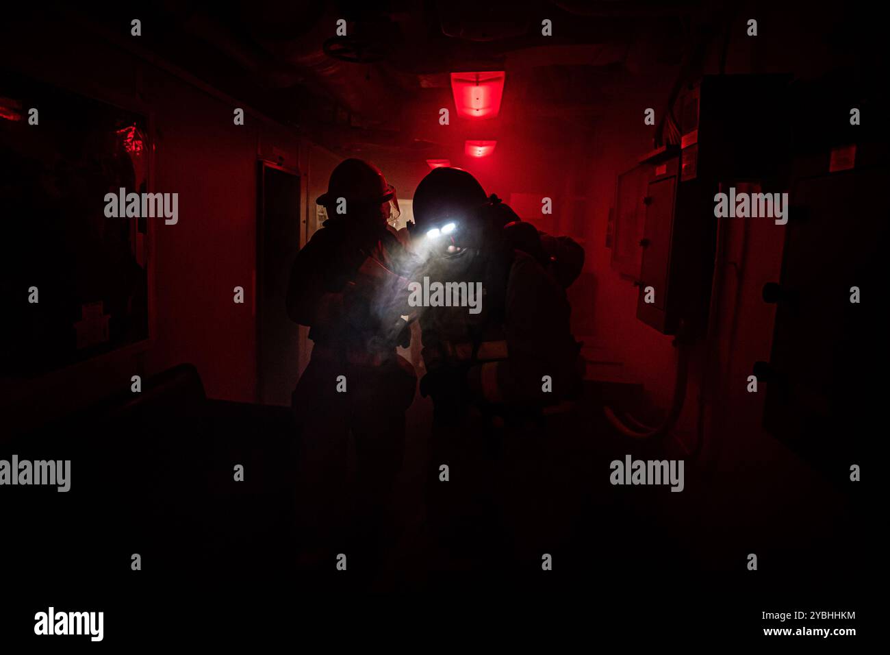 Sailors fight a simulated fire during a general quarters drill aboard ...