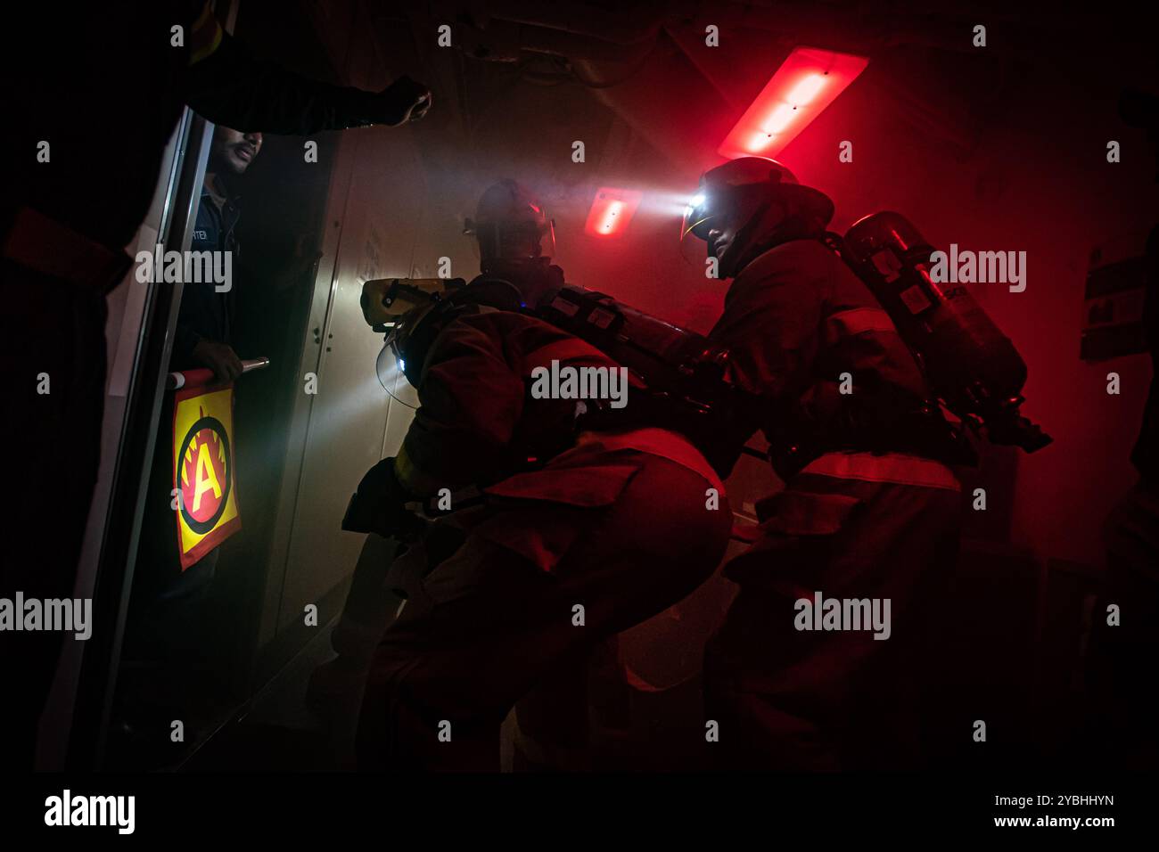 Sailors fight a simulated fire during a general quarters drill aboard ...
