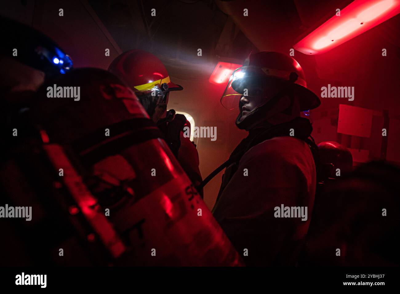 Sailors fight a simulated fire during a general quarters drill aboard ...