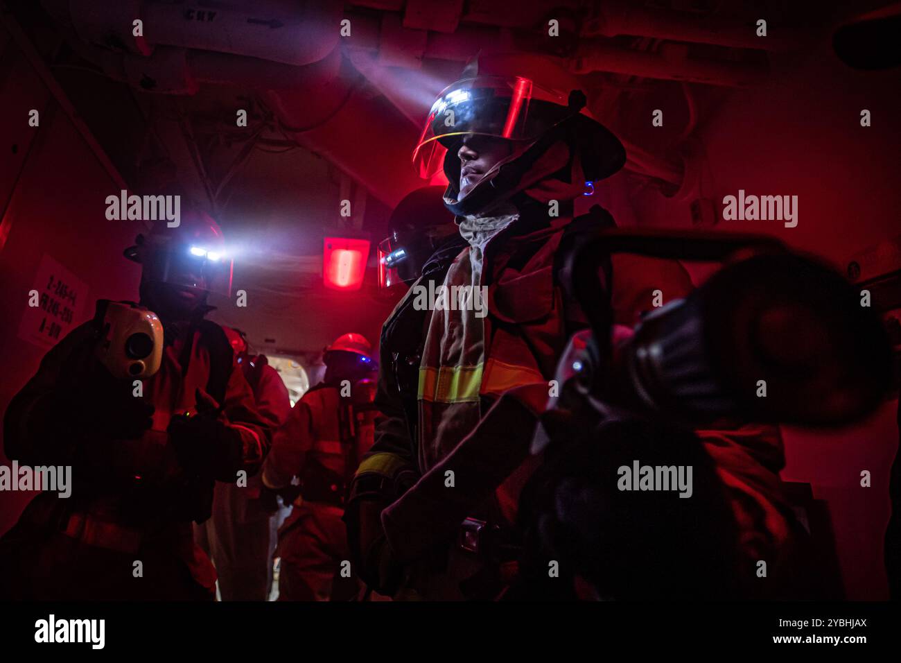 Sailors fight a simulated fire during a general quarters drill aboard ...
