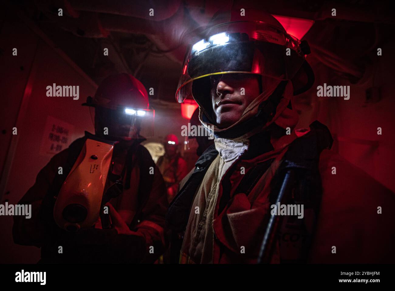 Sailors fight a simulated fire during a general quarters drill aboard ...