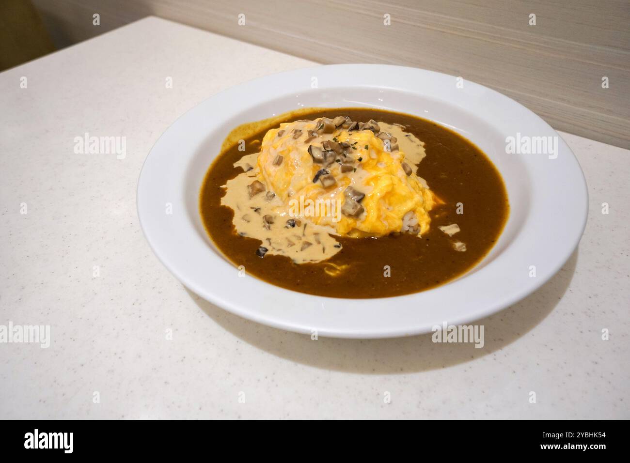 Creamed Mushroom Omelet Curry. Curry rice served in white ceramic plate ...