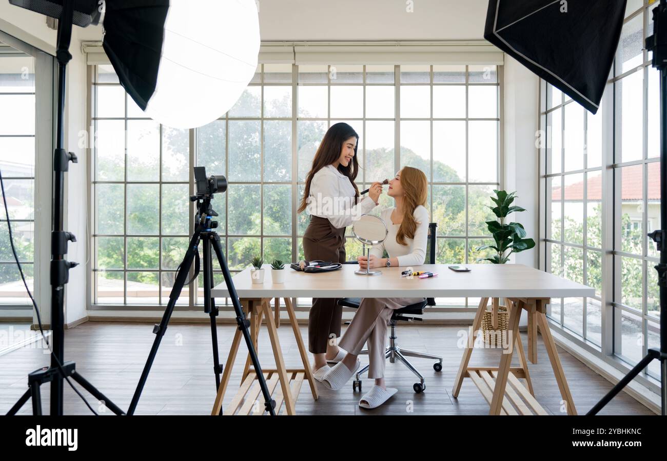 Two asian women creating content for social media. They are using a ...