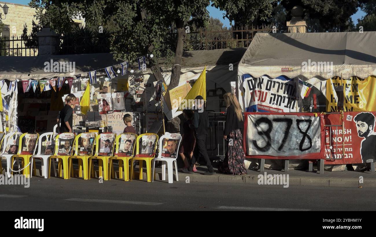 JERUSALEM - OCTOBER 18: People pass by posters bearing photos of ...