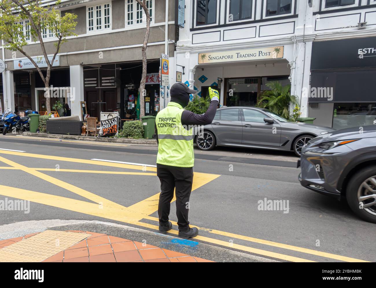 Traffic control officer regulating traffic in Singapore Stock Photo - Alamy
