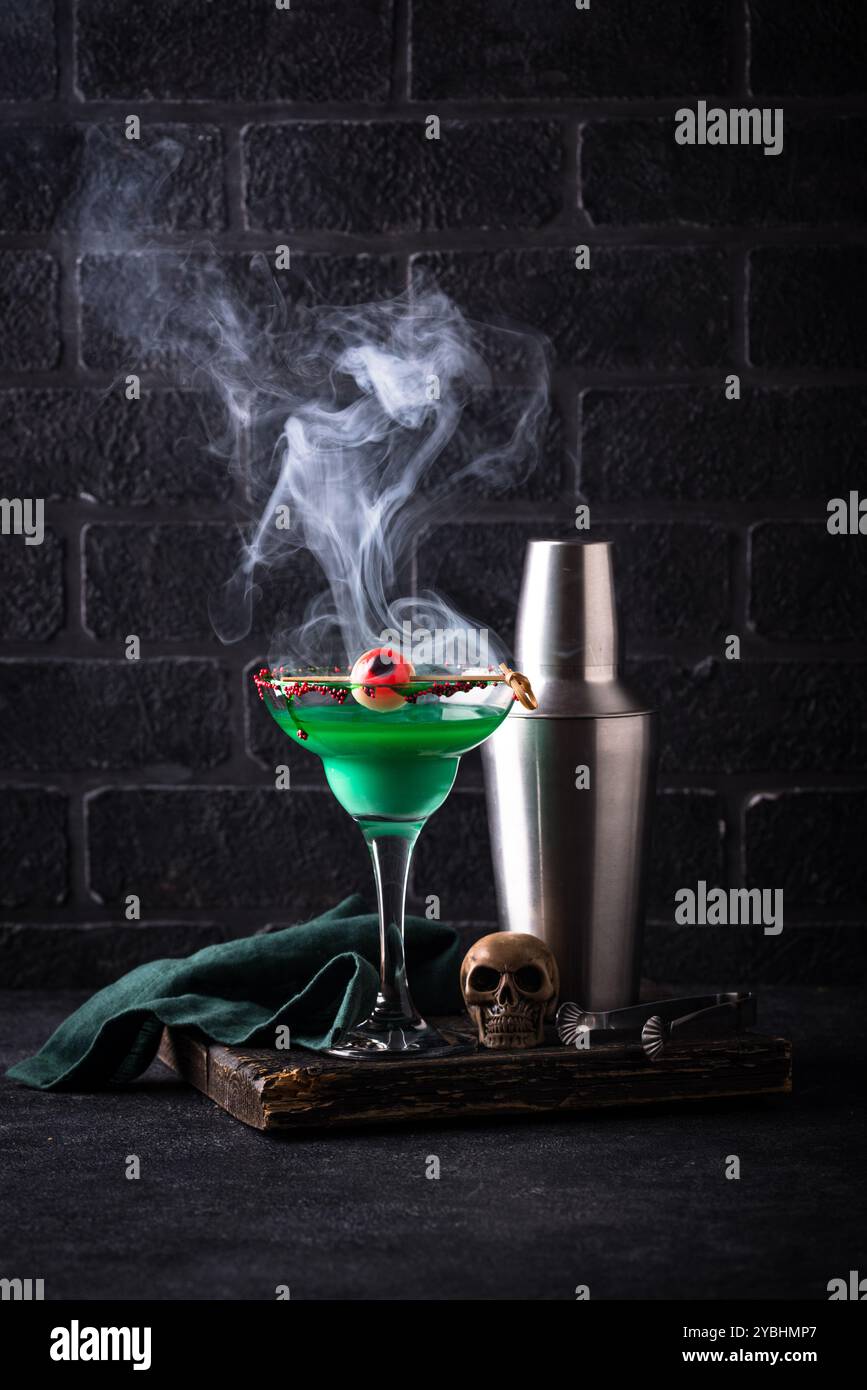 Spooky green cocktail with smoky effect Stock Photo - Alamy