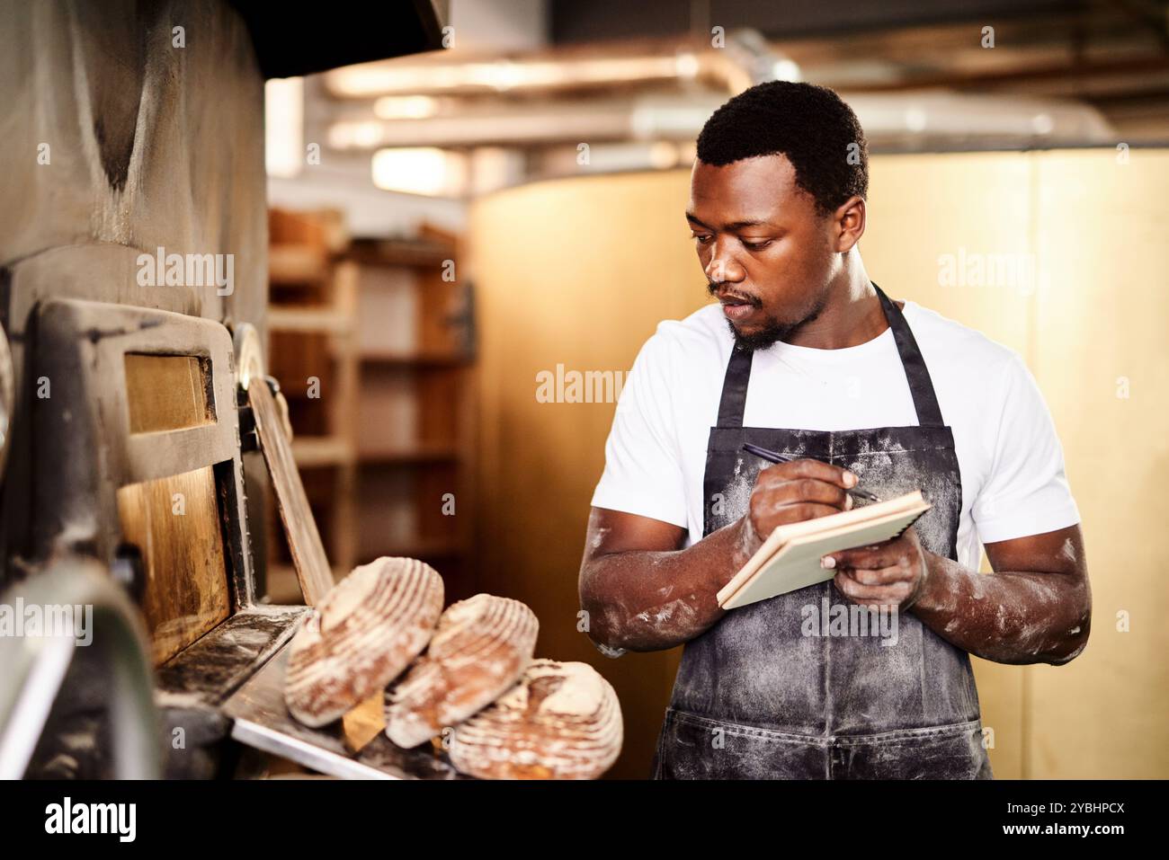 Black man, bread and notes for baker, small business owner and pastry ...
