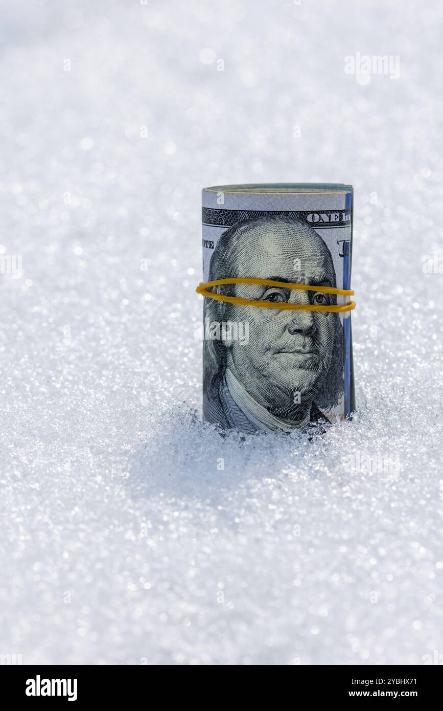 Roll of us dollar banknotes on the snow surface Stock Photo - Alamy