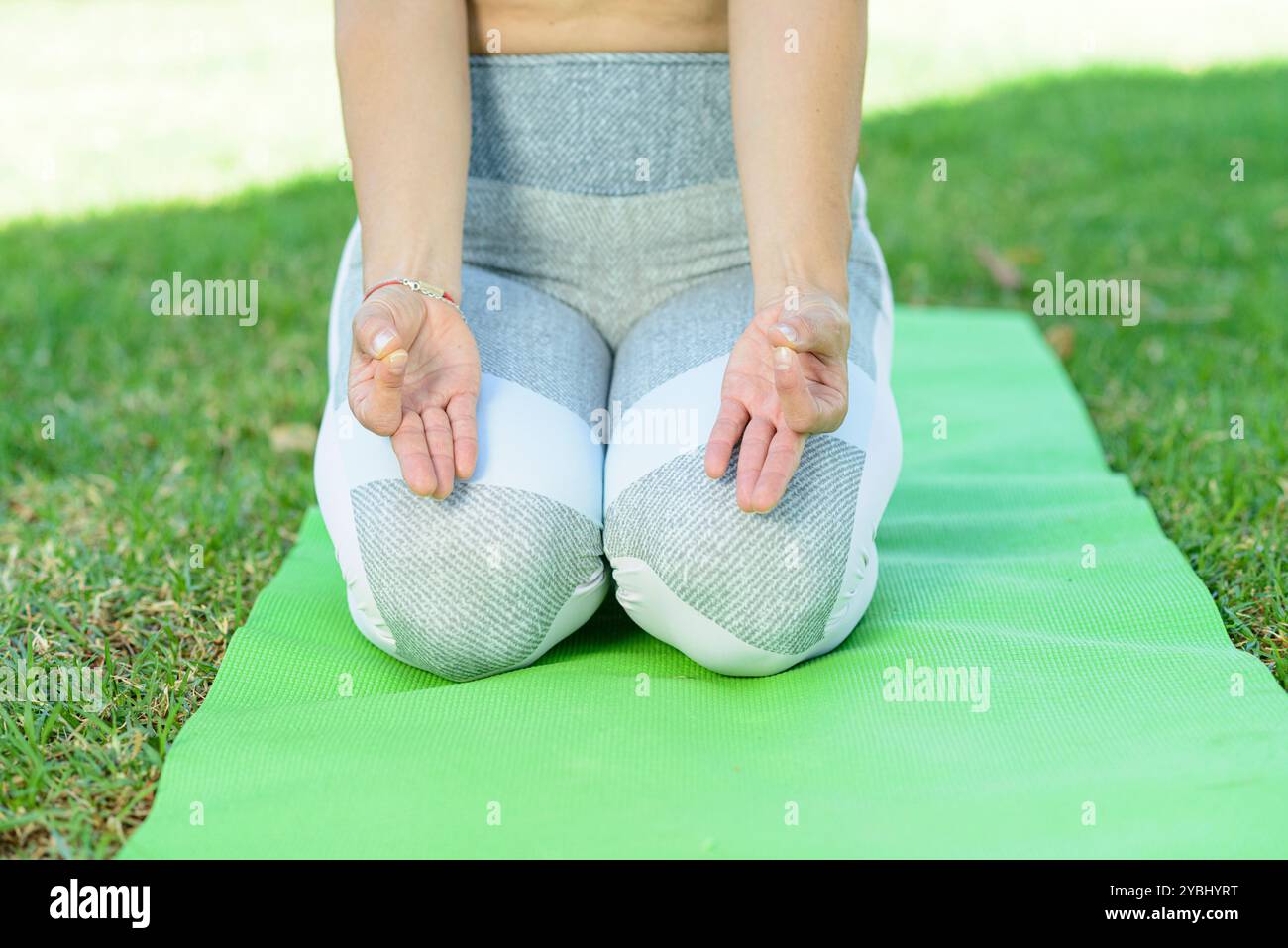 Detail of a woman's hands in meditation posture, outdoors. Concepts of ...