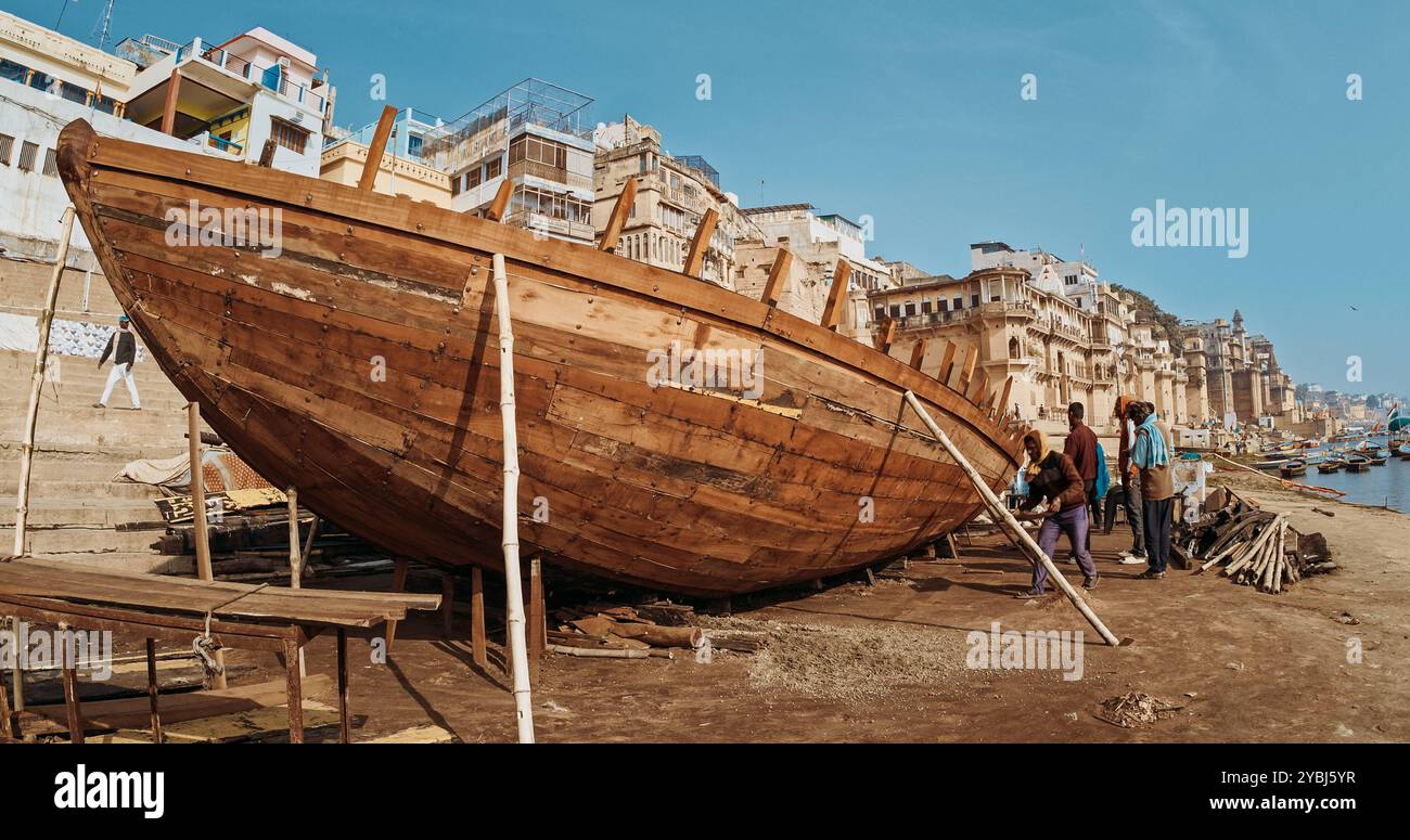 Varanasi, Uttar Pradesh, India. Indian men Workers are repairing and ...