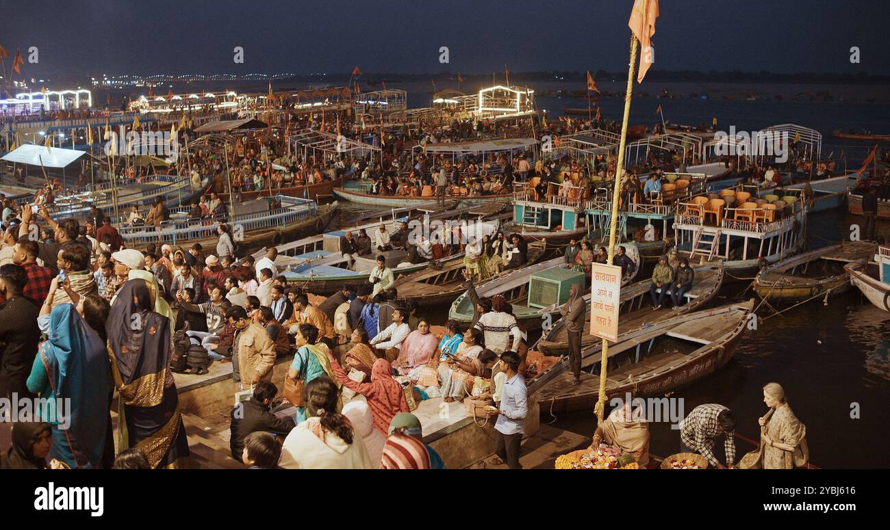 Varanasi, Uttar Pradesh, India. Many people on boats waiting start ...